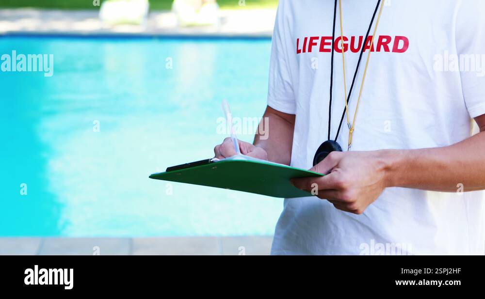 Smiling lifeguard writing on clipboard at poolside Stock Video Footage ...