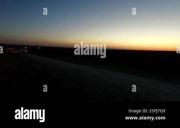 a sunset in the middle of a field of the desert Stock Video Footage - Alamy