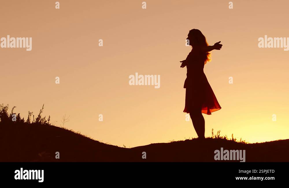 Girl silhouette at sunset dancing whirling. Girl woman dancer spinning ...
