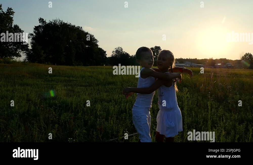 Silhouettes, figures of children, boy and girl hugging against the ...