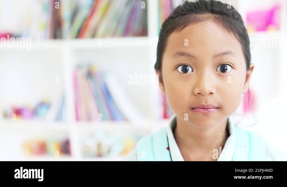 Toothless child smiling in the library Stock Video Footage - Alamy