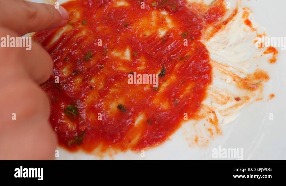 Empty dirty plates with the remains of ketchup. Men's hands paint an ...