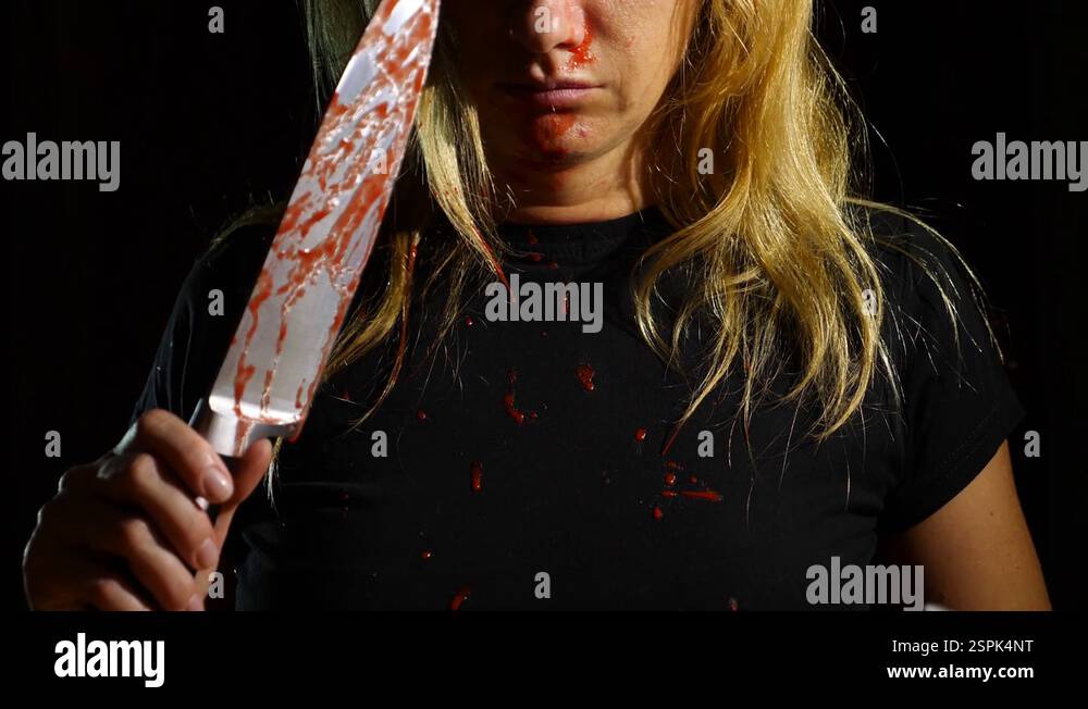 A mad woman, a gripping knife, covered in blood, the hands of a ...