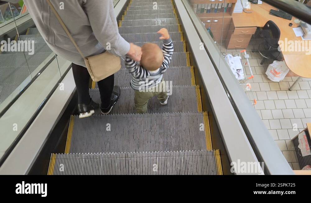 mother and baby come out of escalator Stock Video Footage - Alamy