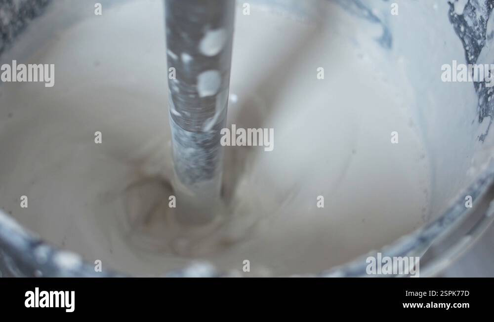 machine mixing gypsum in a bucket electric plaster whisk slow motion ...