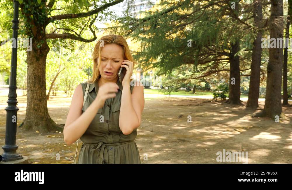 the woman feels sad and crying, talking to someone on the mobile phone ...