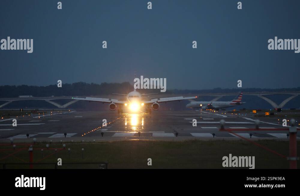 Airplane at Reagan National Airport on Runway at Dusk Slow Motion Stock ...