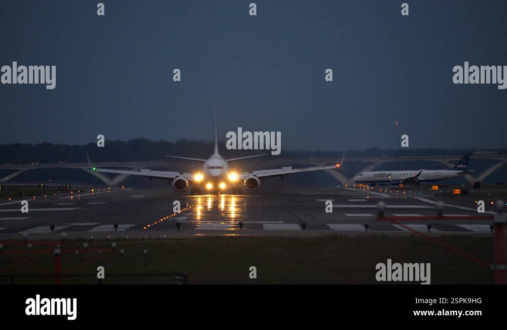 Airplane at Reagan National Airport on Runway at Dusk Bright Light ...