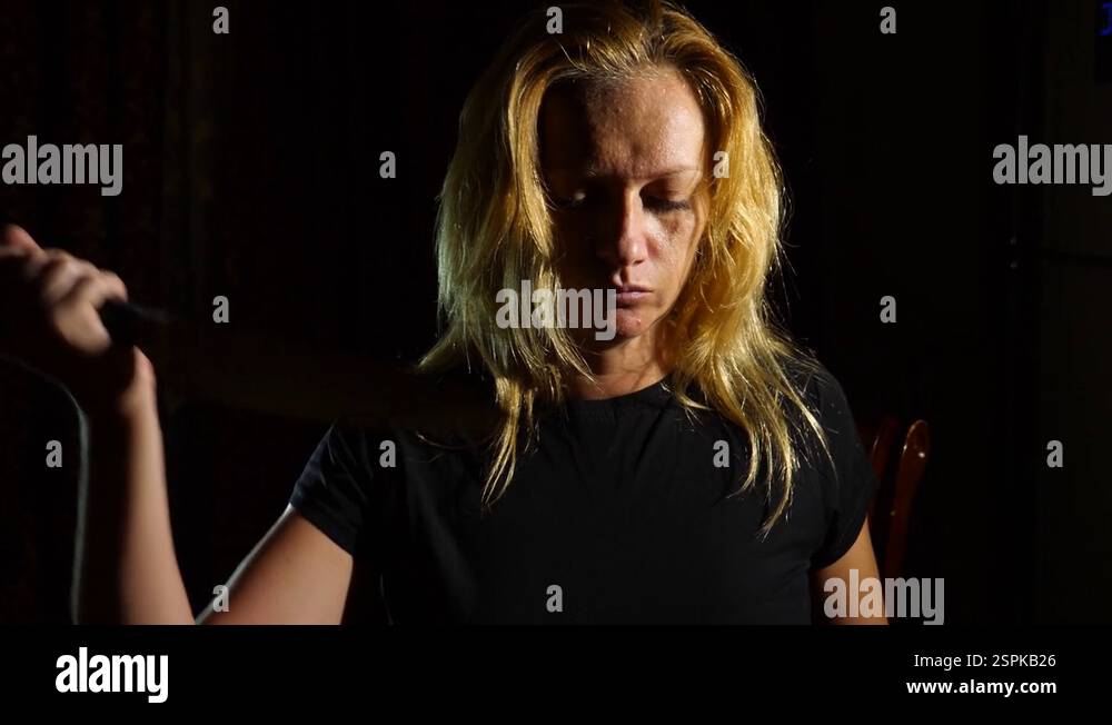 A mad woman, a gripping knife, covered in blood, the hands of a ...