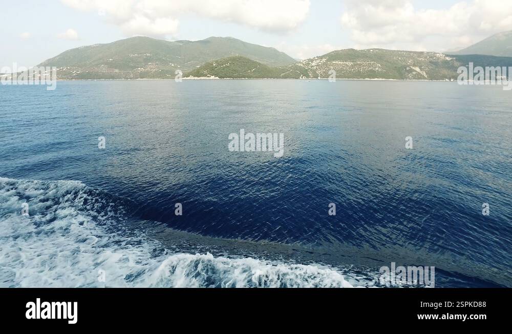 Cruise ship and it's engine propellers churn the water into waves ...