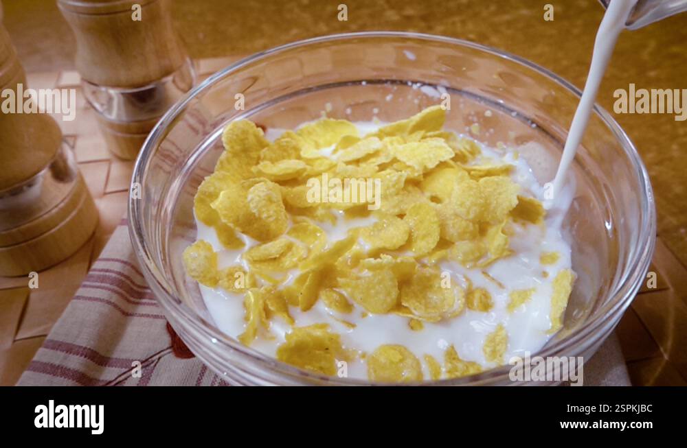 Crispy yellow corn flakes into the bowl for the morning a delicious ...