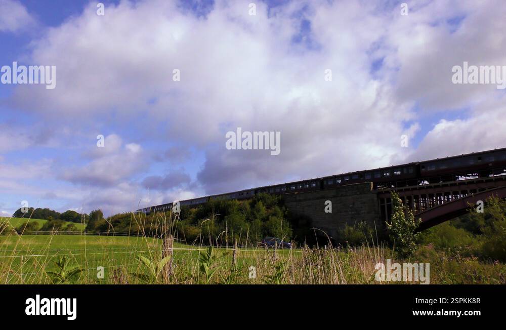 Diesel engine pulling steam train carriages country bridge Stock Video ...