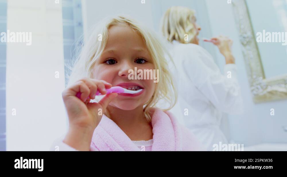 Girl brushing teeth in bathroom 4k Stock Video Footage - Alamy