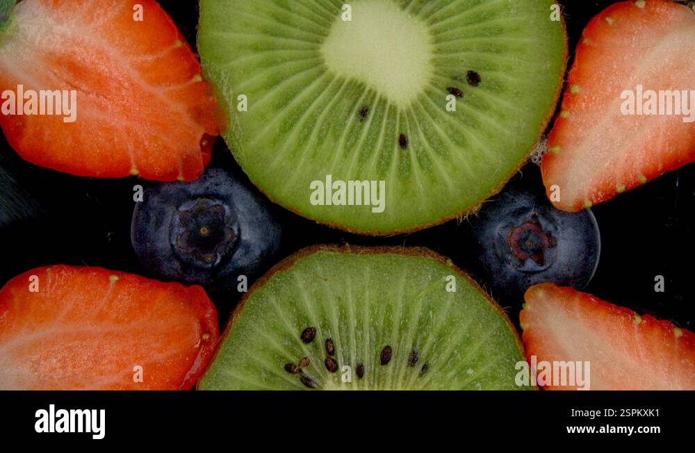 Fresh fruit being squashed in slow motion for a modern healthy eating ...