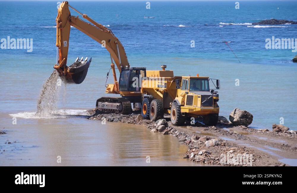 excavator and truck moving sand working on beach slow motion 4k Stock ...
