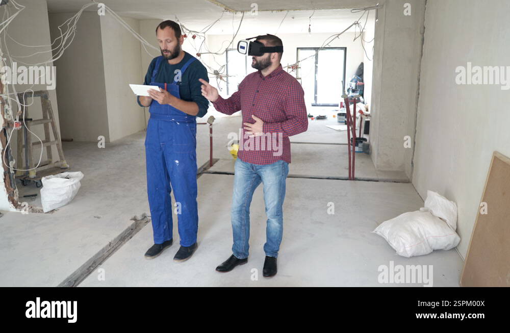 Male architect and worker with vr goggle and tablet setting up project ...