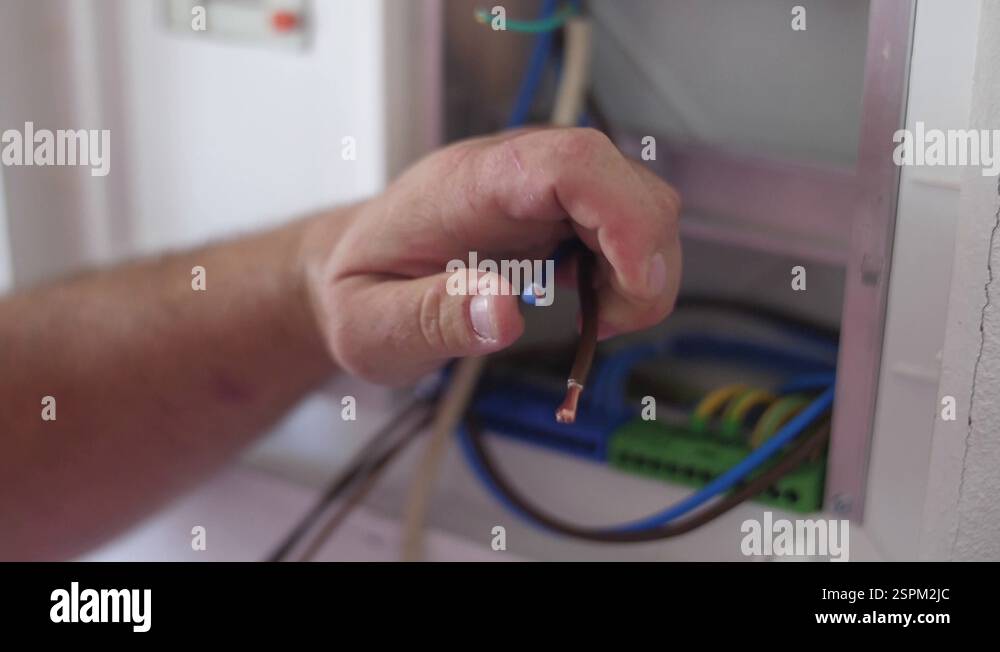 strip electrical wire with plier in electric instalation slow motion ...