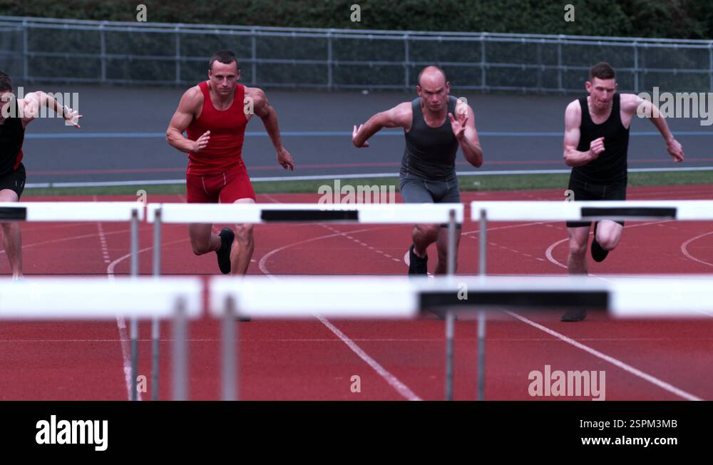 Male hurdle athletes training on running track, shot on Phantom Flex at ...