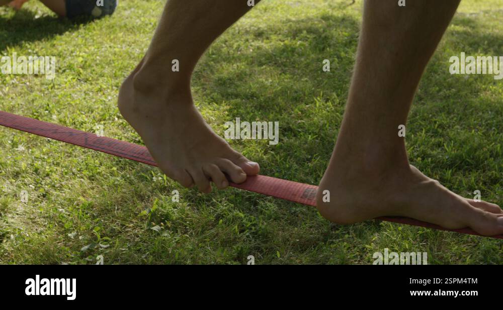 Man feet balances on slack line tight rope - extreme close up Stock ...