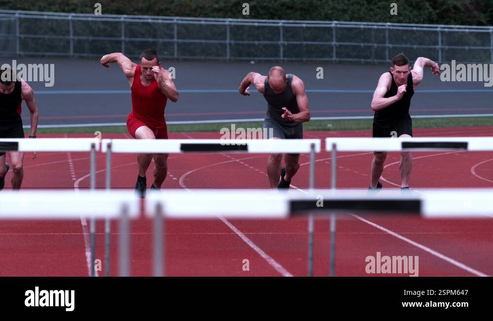 Male hurdle athletes training on running track, shot on Phantom Flex at ...