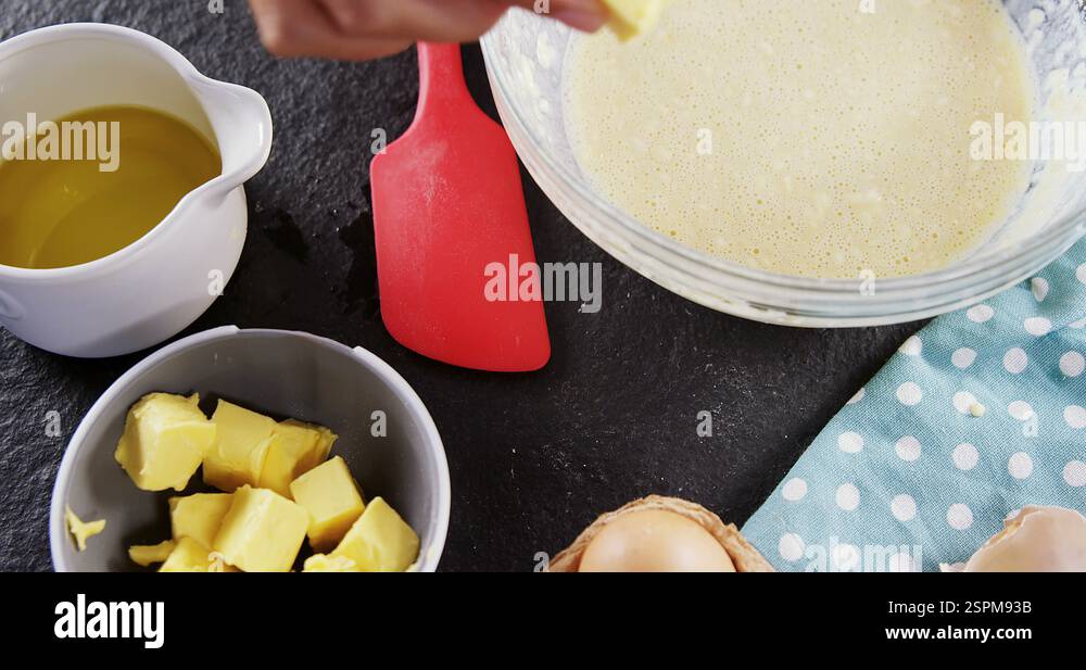 Woman adding butter cubes to batter in bowl 4k Stock Video Footage - Alamy