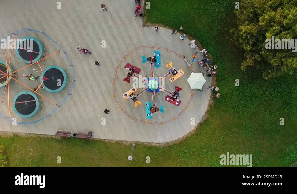 Summer, aerial view on a children's amusement park, carousel in motion ...