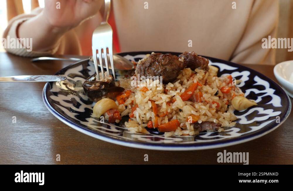 someone eats pilaf in a restaurant of national cuisine. 4k, slow motion ...