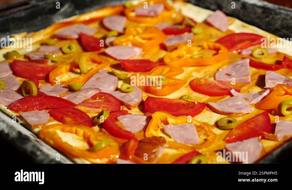 close-up, hands spread the filling on the dough for pizza. cooking ...
