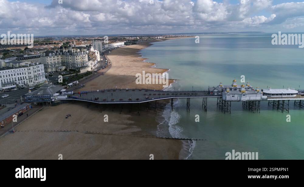 Aerial dolly view of the seafront and the Victorian pier in Eastbourne ...