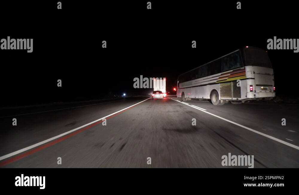 POV timelapse fast car drive old countryroad at night. Flow of oncoming ...
