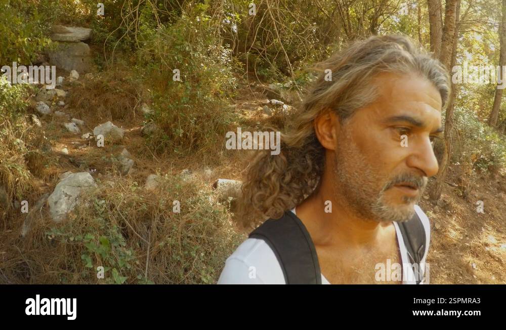 turkish long-haired man close-up in ruins in the forest Stock Video ...