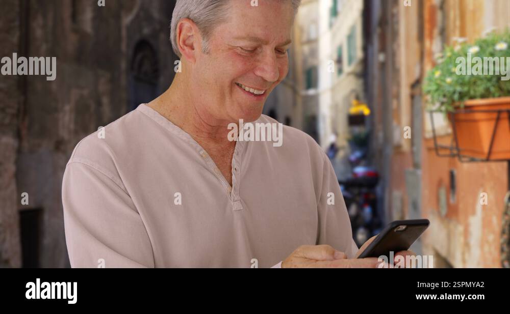 Old white man in street in Italy texts friends on phone Stock Video ...