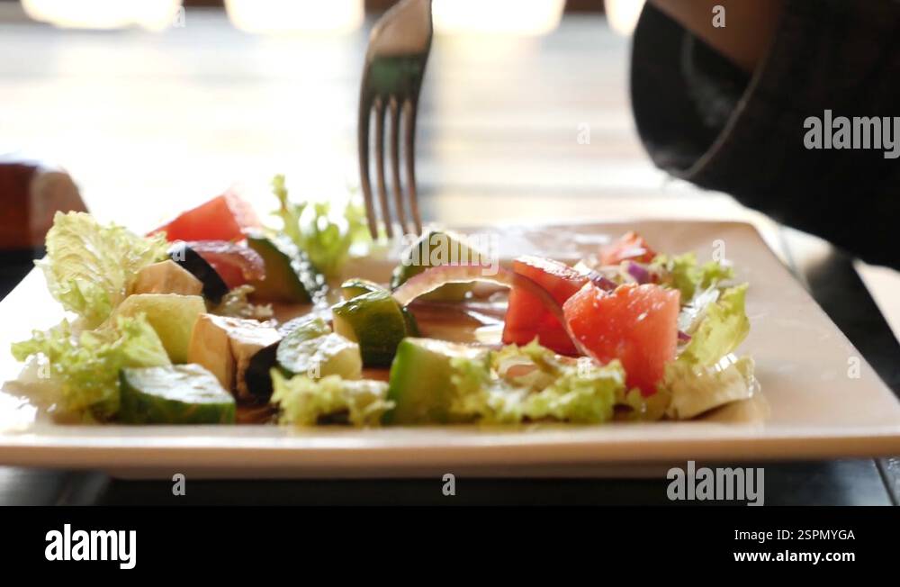 someone is eating a Greek salad in a fast food restaurant. 4k, slow ...
