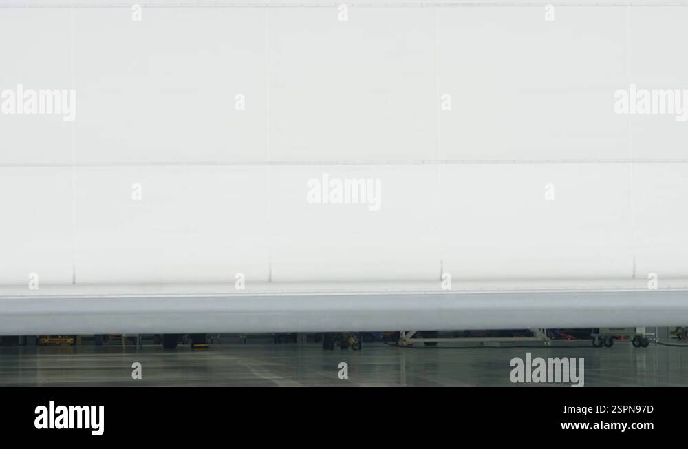 Roller shutter door and plane in hangar background. Business jet ...