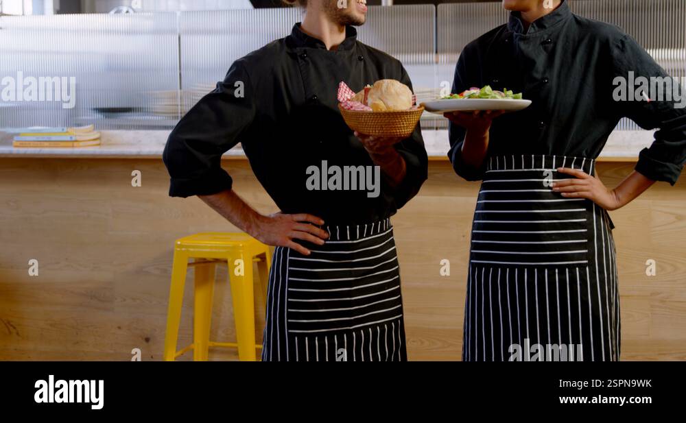 Smiling chefs presenting their dish at commercial kitchen 4k Stock ...