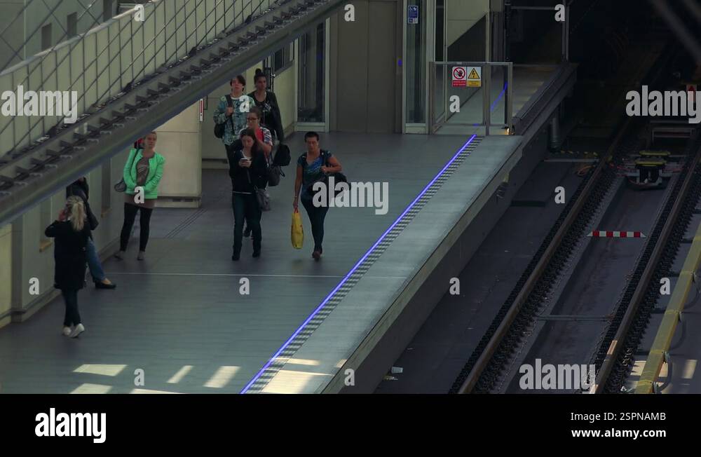 People walk and wait on a platform in a subway station - top view Stock ...