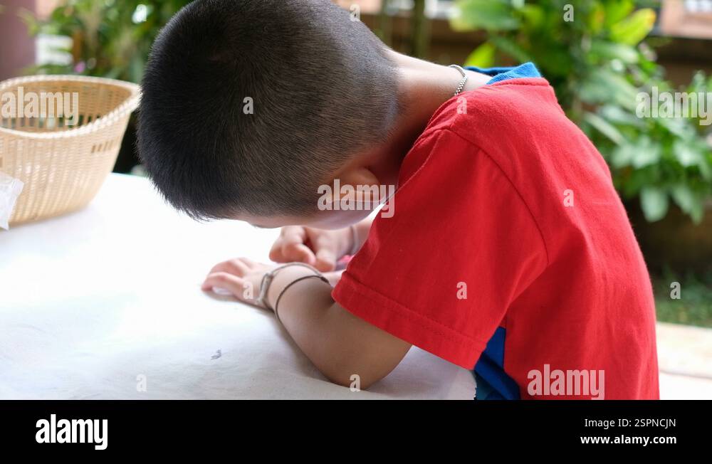 Close up boy drawing on white paper from behind with nature background ...