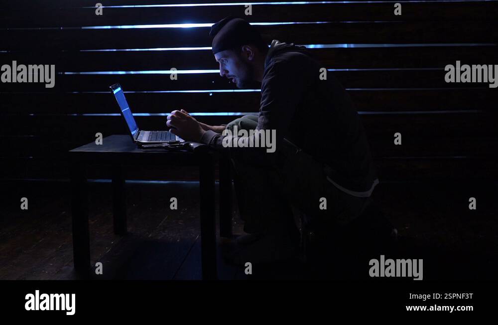 comic funny hacker commits a cyber attack with a laptop and a gun in ...