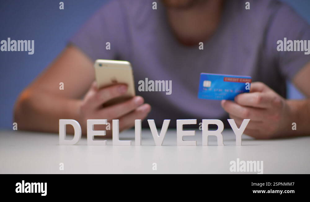 Man using mobile phone orders delivery food to house and payment by ...