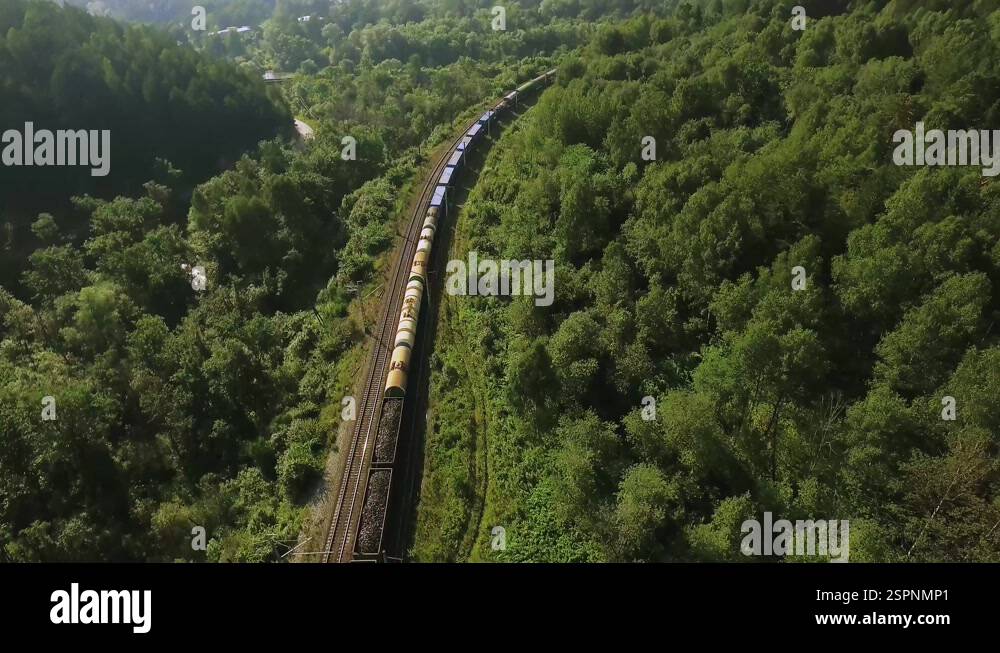 Freight train on winding Trans Siberian railway at summer day in Ural ...