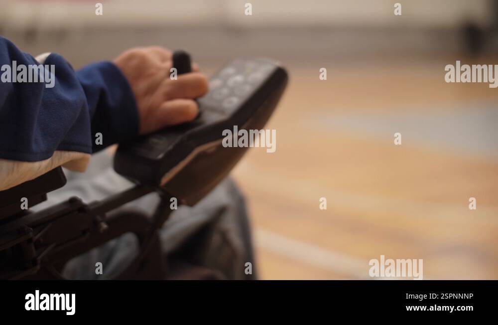 disabled man safely drives a power wheelchair using joystick slow ...
