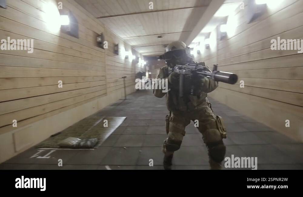 Special forces soldier in full gear firing automatic weapons running to ...