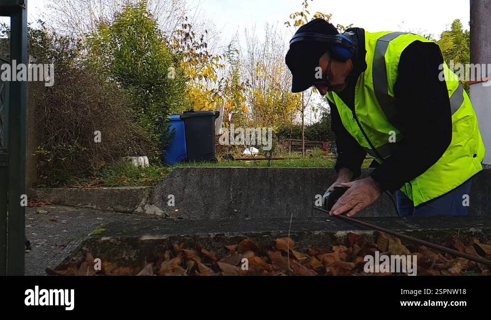 A worker. saws off a piece of a metal pin with a circular saw Stock ...