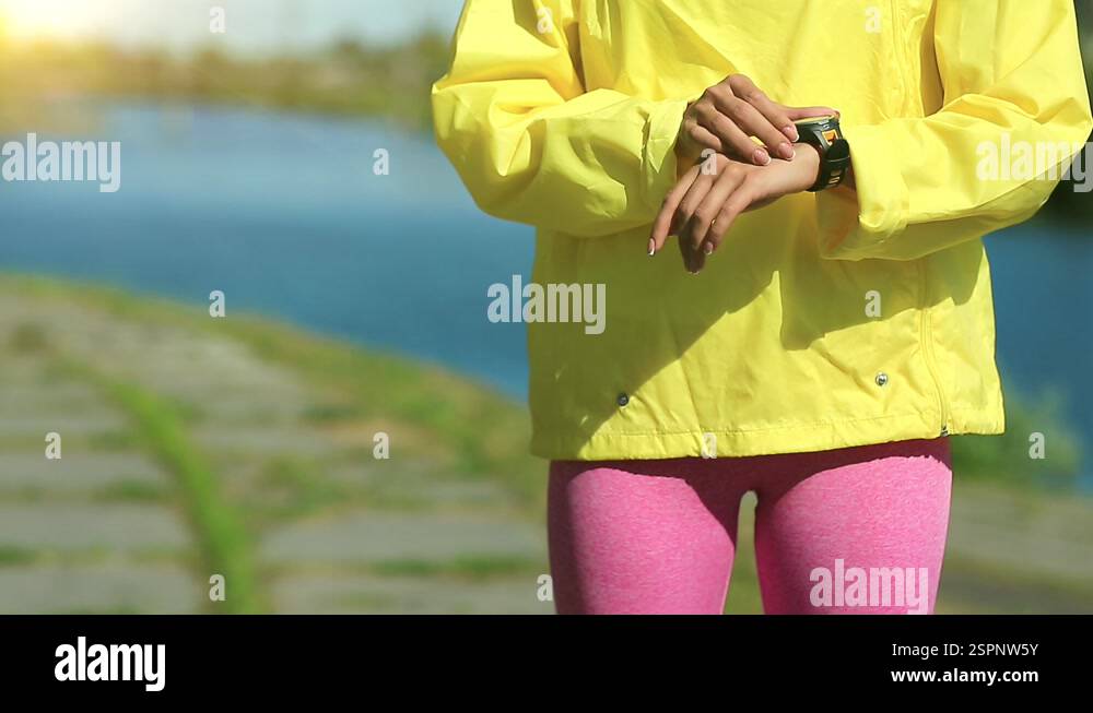 Active young woman note down the time in his watch and start running ...