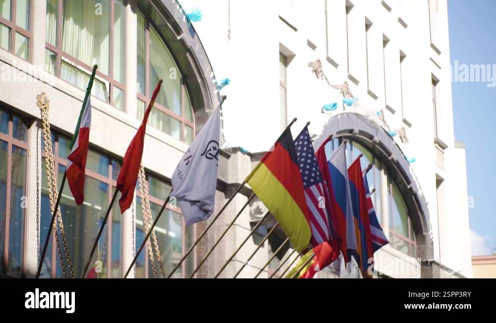 Waving flags in front of building. World Flags in front of historic ...