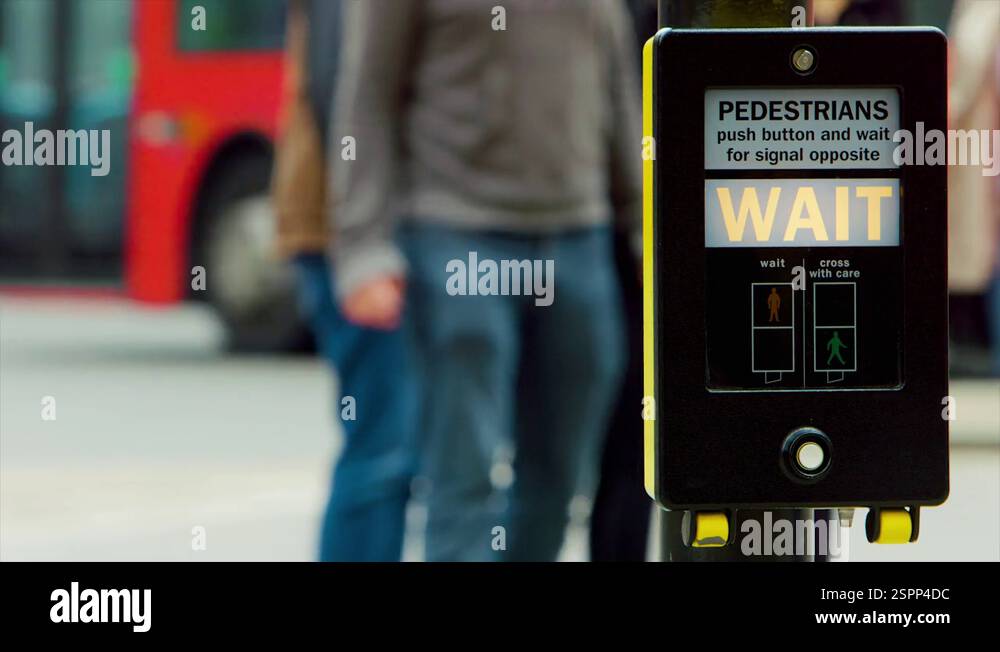 Walk or wait sign next to a crosswalk in London, UK. Warning signal, safety Stock Video Footage ...