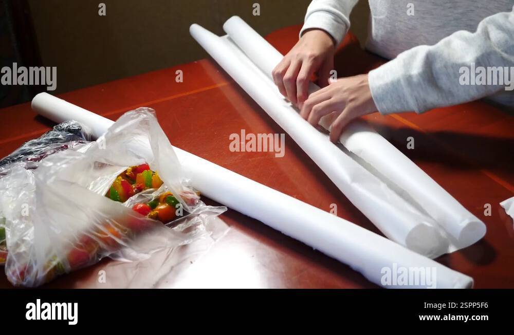 Mom and her daughter collect a parcel with oriental sweets and fruits ...