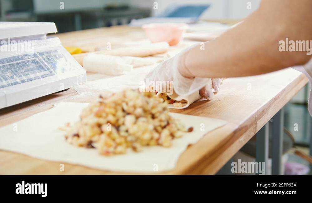 Cook bakes and forming apple pies in the bakery Stock Video Footage - Alamy