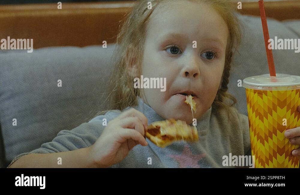 children eat pizza at the cafe and eat potatoes Stock Video Footage - Alamy