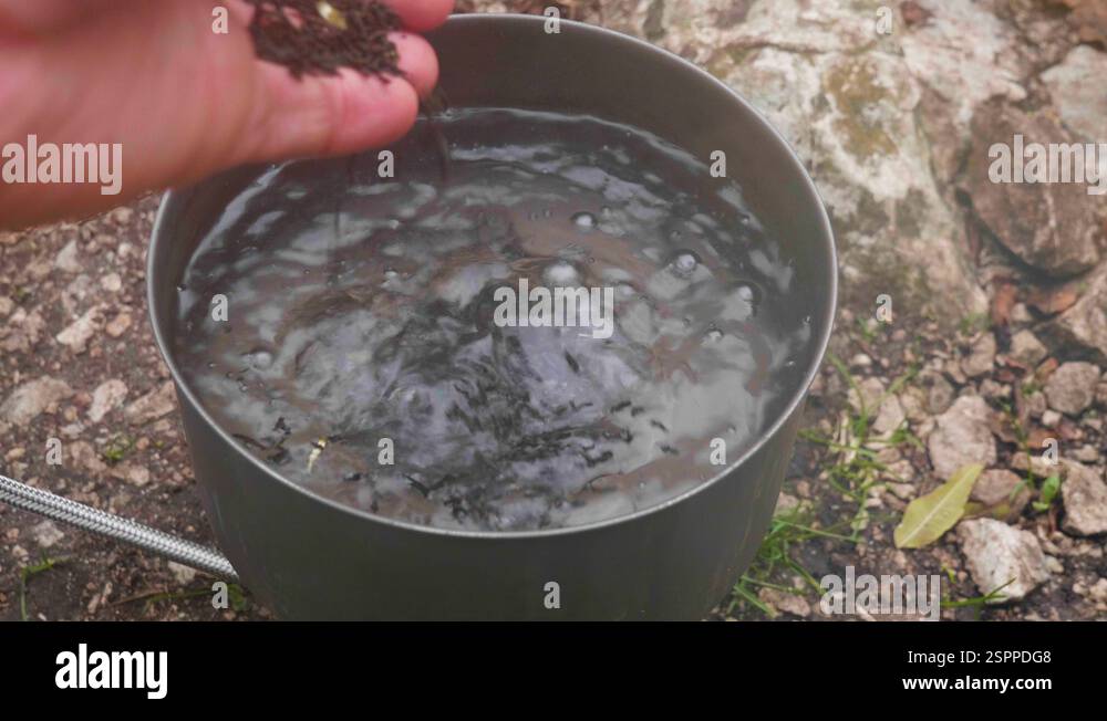 Man is cooking tea on touristic pot with boiling water Stock Video ...